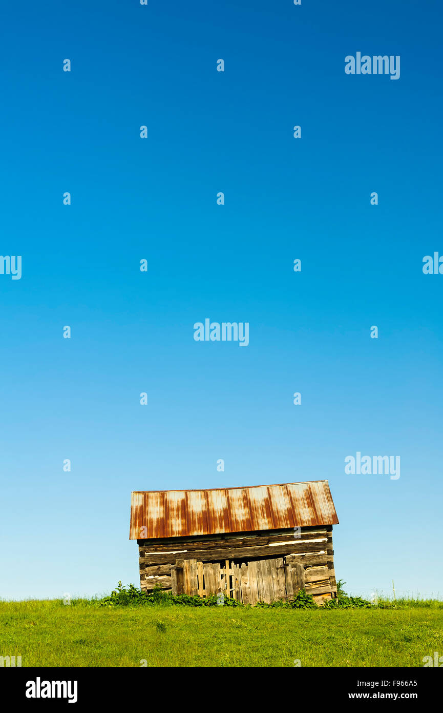 An old shed sits alone on a grassy hillside on the Niagara Escarpment ...