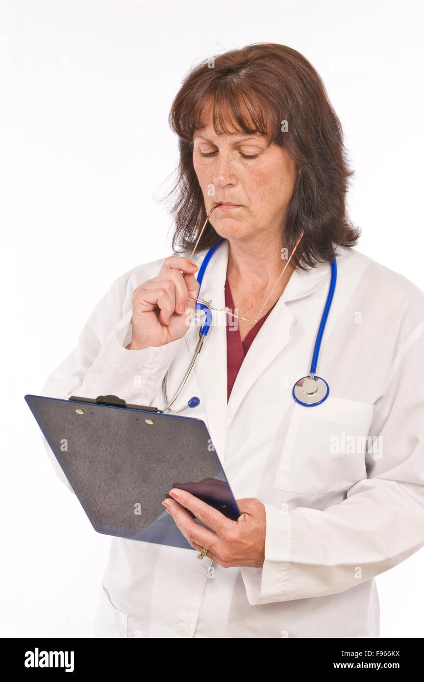 Female Doctor studies patient notes on her clipboard Stock Photo - Alamy