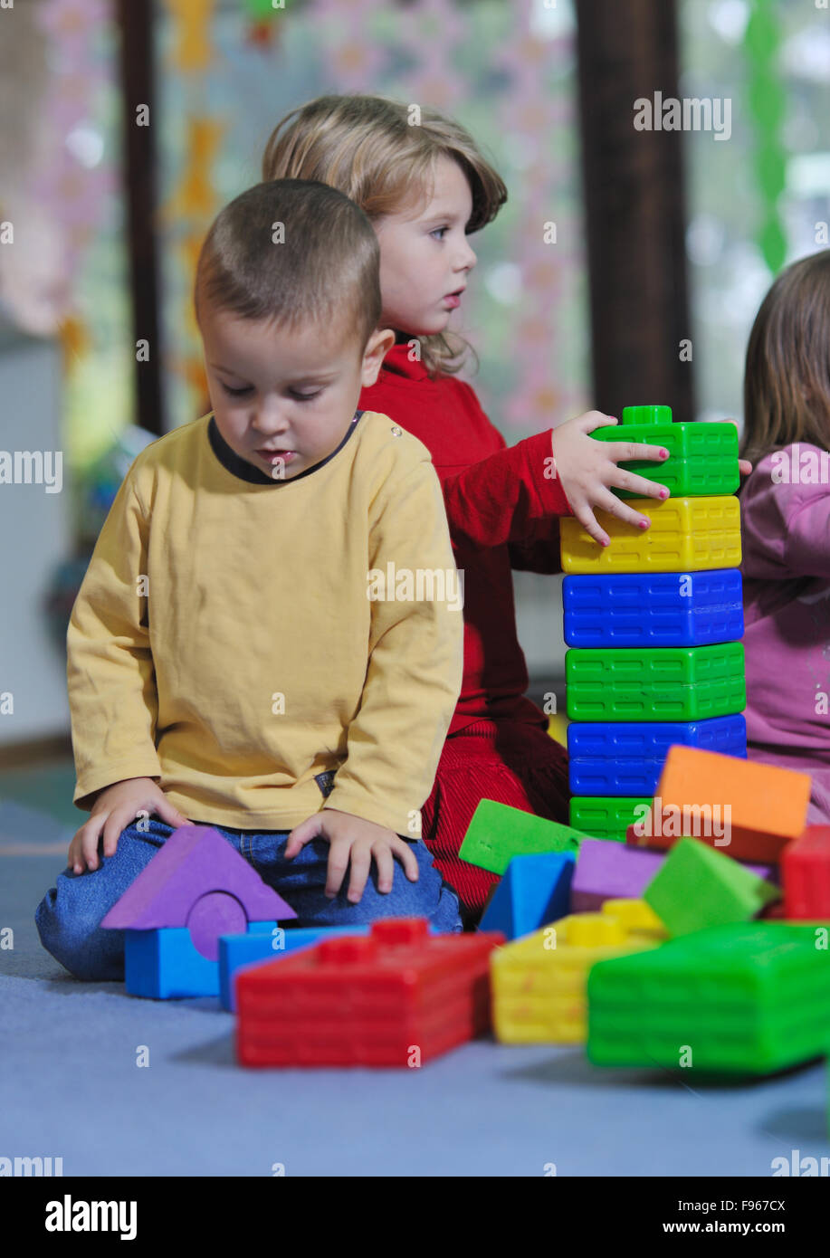 happy child kids group have fun and play at kindergarden indoor ...