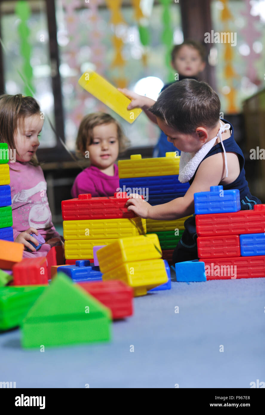 happy child kids group have fun and play at kindergarden indoor ...