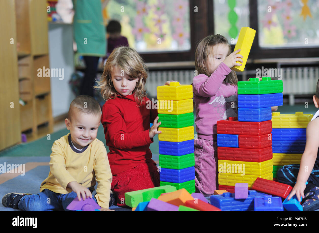 happy child kids group have fun and play at kindergarden indoor ...