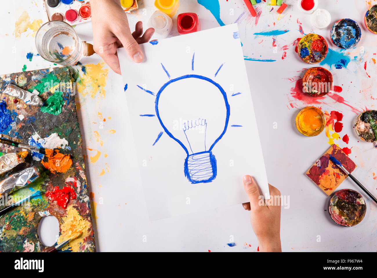 Creative idea concept with colorful paints over white paper Stock Photo ...