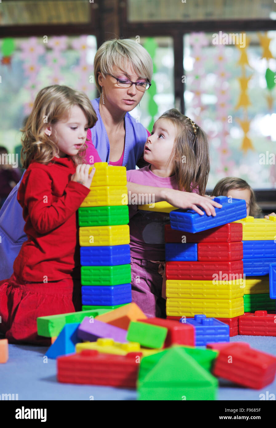 happy child kids group have fun and play at kindergarden indoor ...