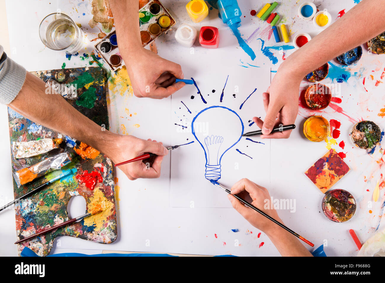 Creative idea concept with colorful paints over white paper Stock Photo ...