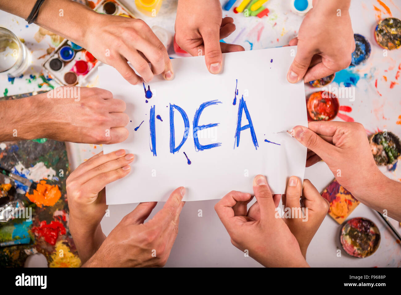 Creative idea concept with colorful paints over white paper Stock Photo ...