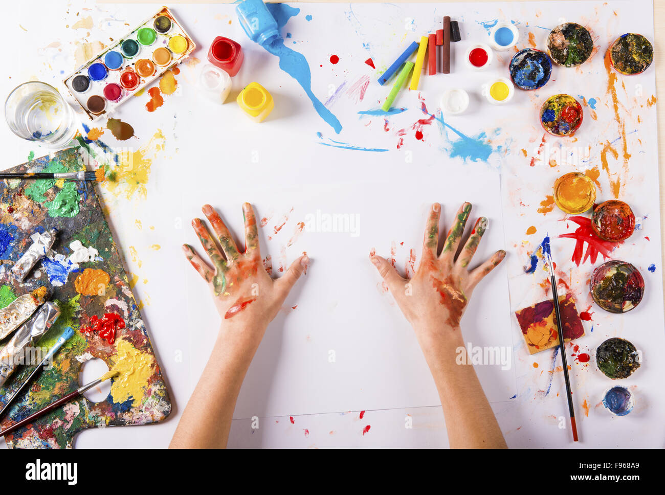 Creative art concept with colorful paints over white paper Stock Photo ...