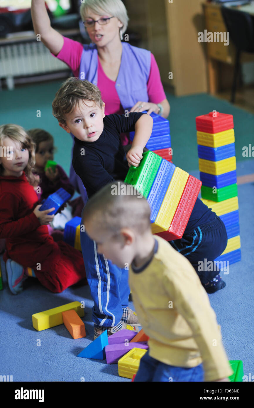 happy child kids group have fun and play at kindergarden indoor ...