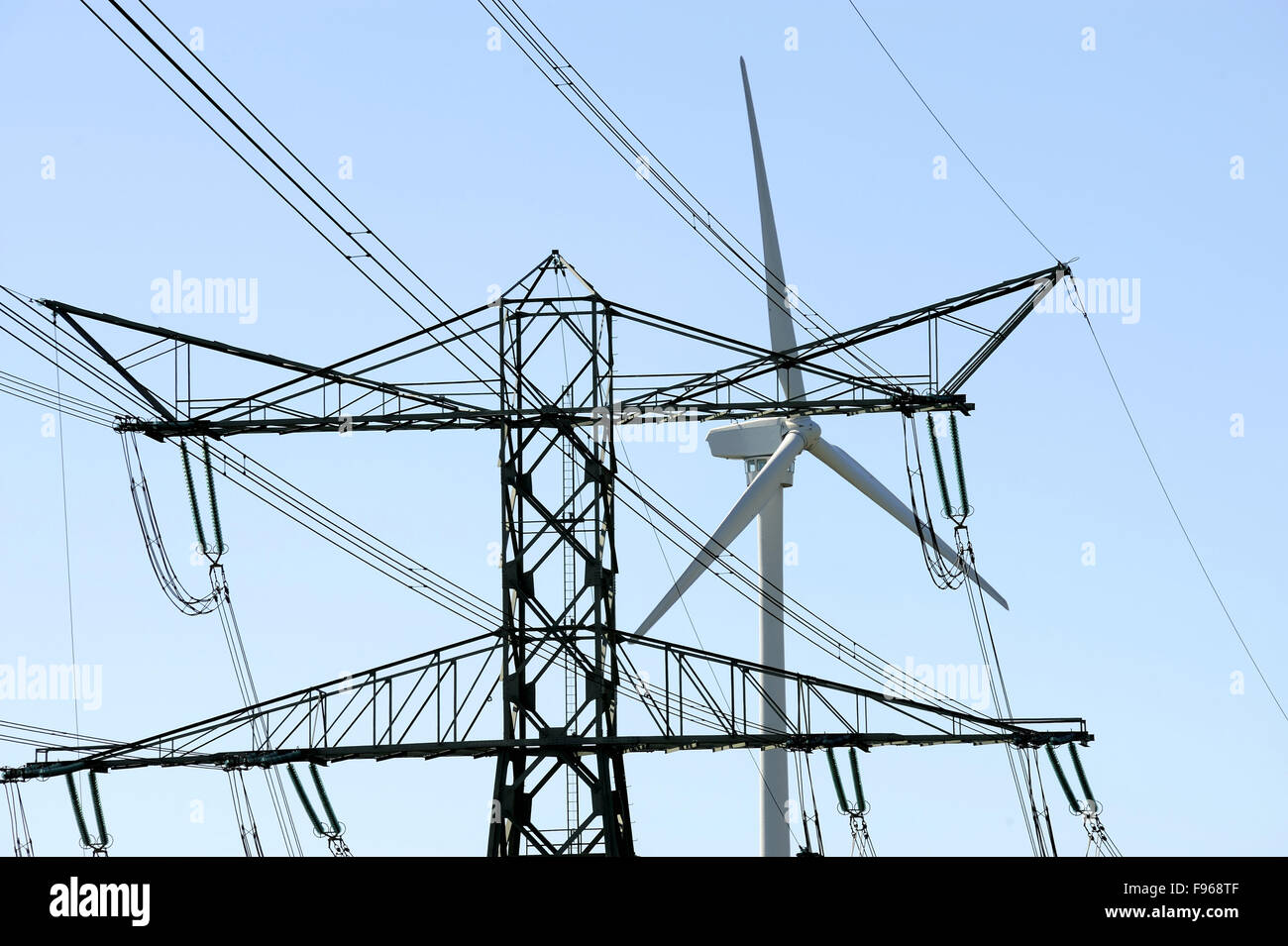 Power pylon and wind turbine against clear blue sky Stock Photo - Alamy