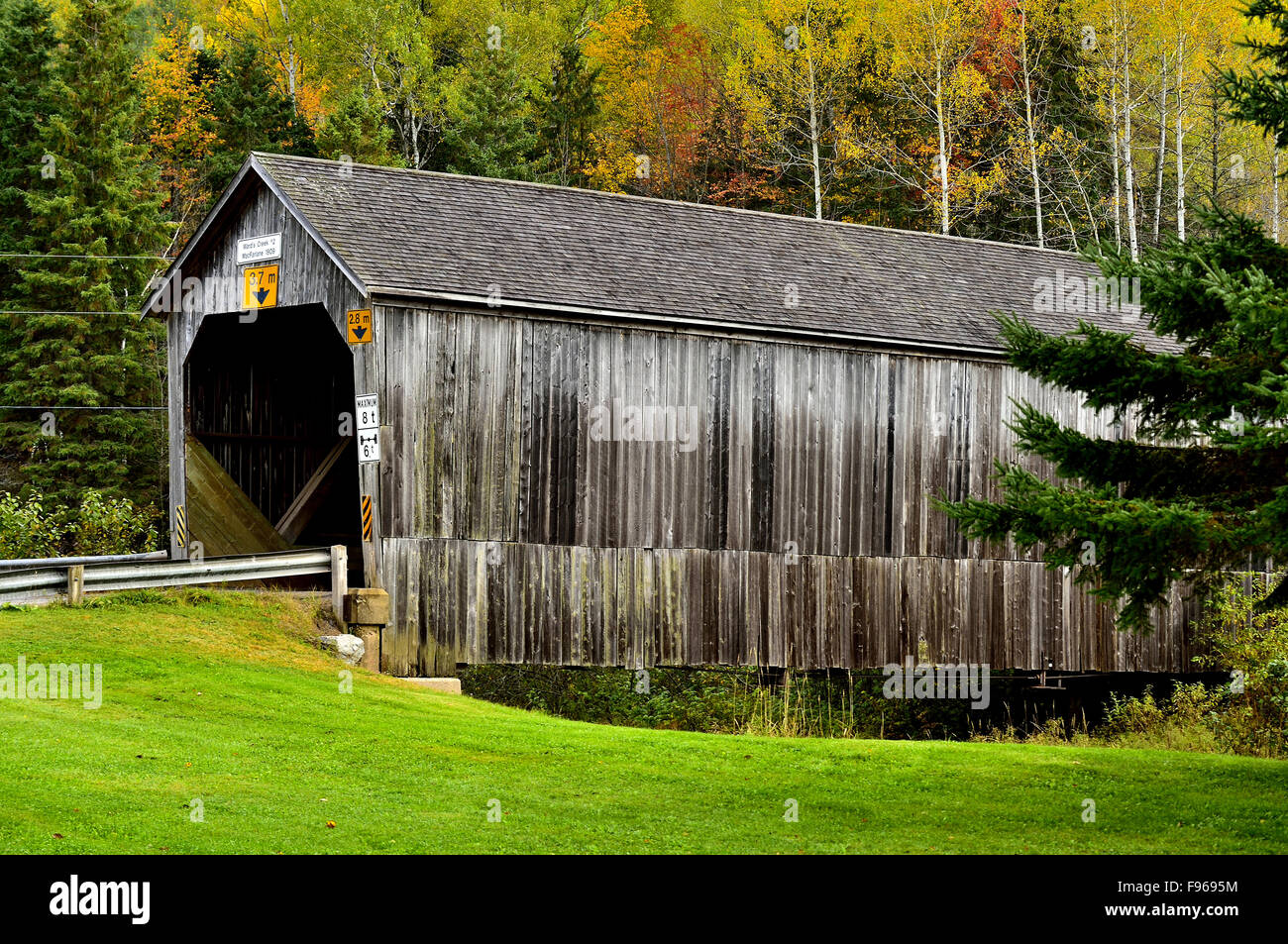 A fall landscape view of the iconic wooden covered bridge spanning the ...