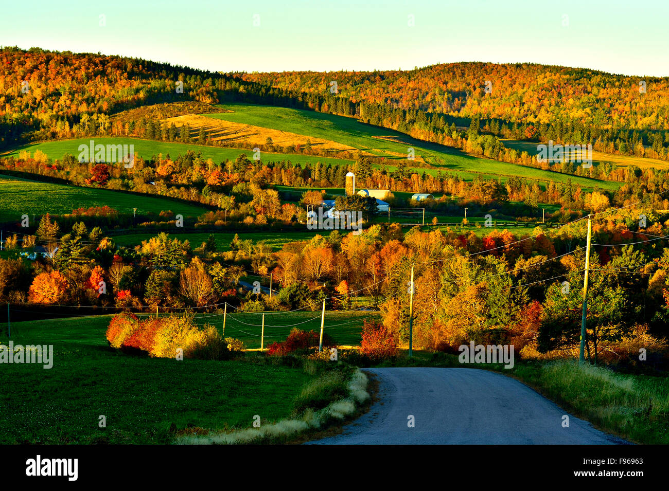 A colorful autumn landscape of a farm with fields intersected by the ...