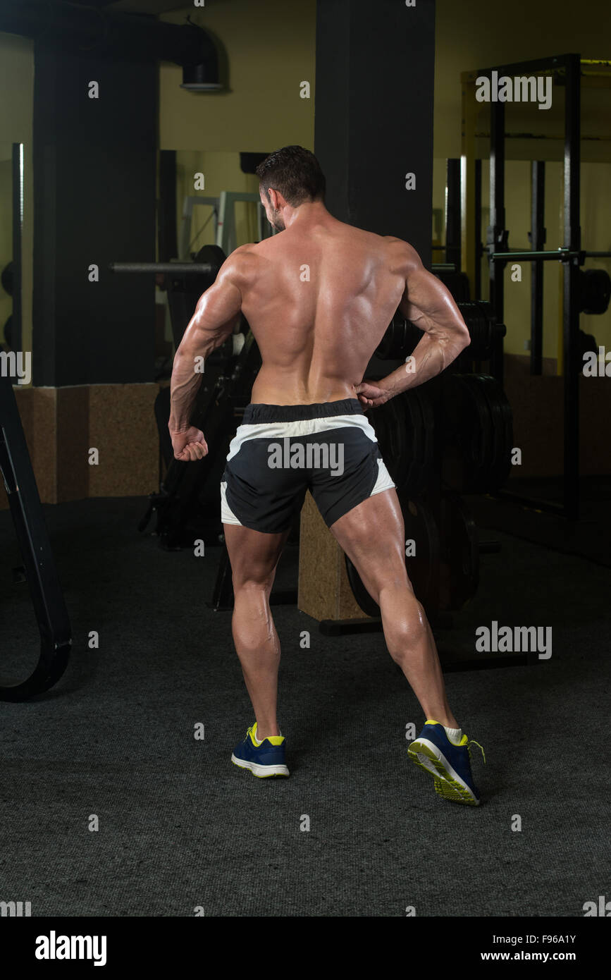 Serious Man Standing Strong In The Gym And Flexing Muscles Stock Photo ...