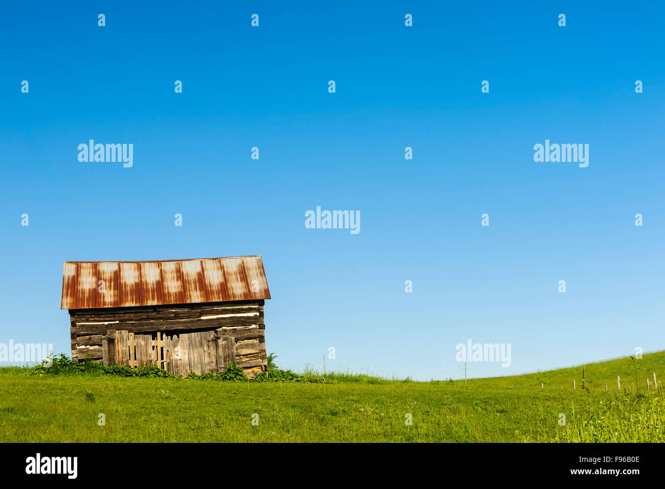 An old shed sits alone on a grassy hillside on the Niagara Escarpment ...