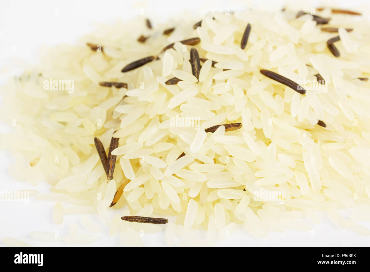 Closeup of long rice mixed with wild rice isolated on white background ...