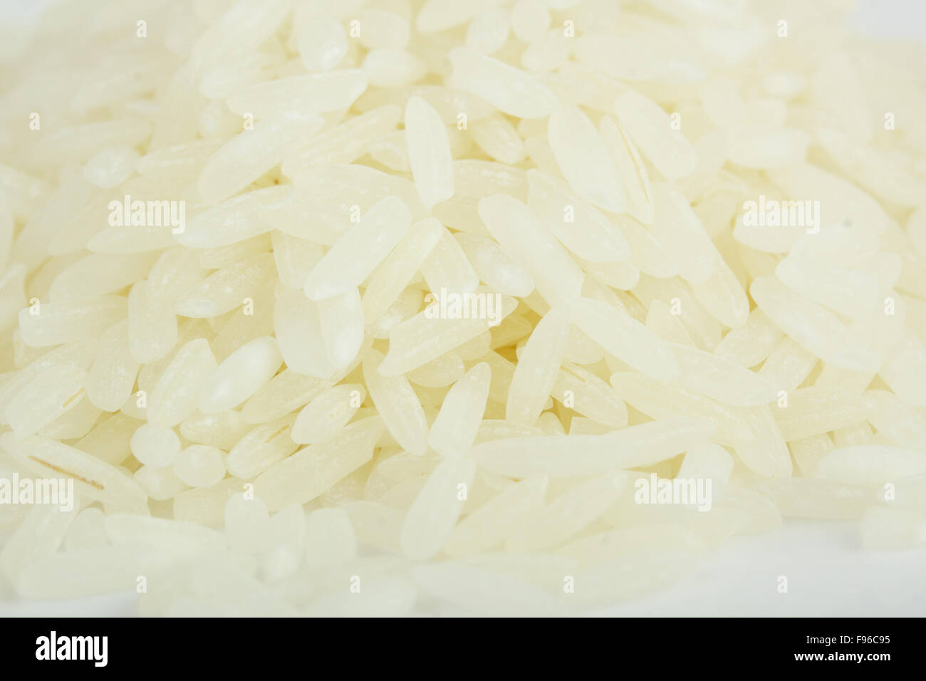 Pile of organic rice (on white Stock Photo - Alamy