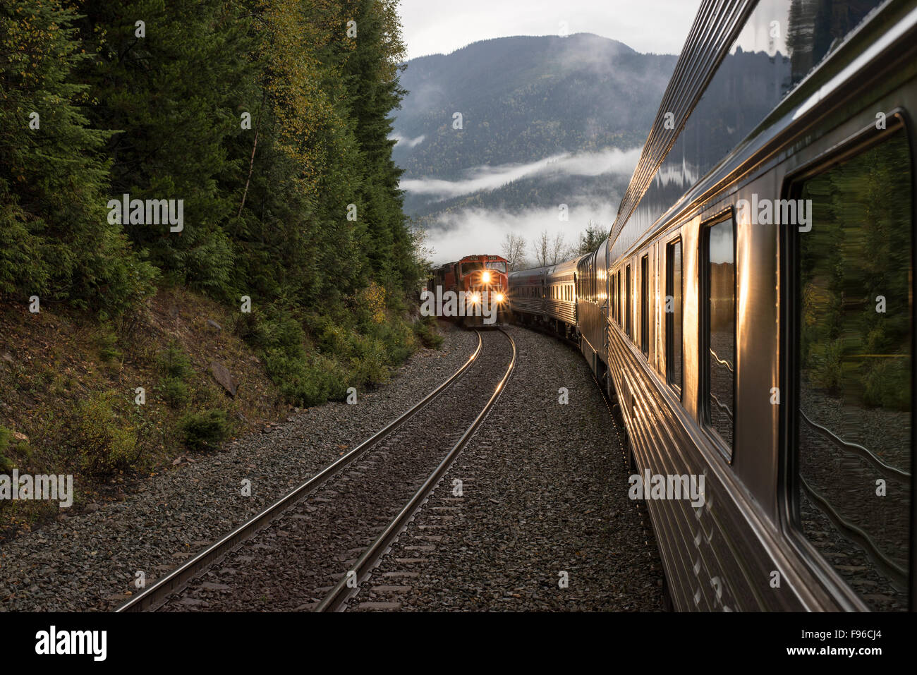 Passenger train meeting a freight train Stock Photo - Alamy