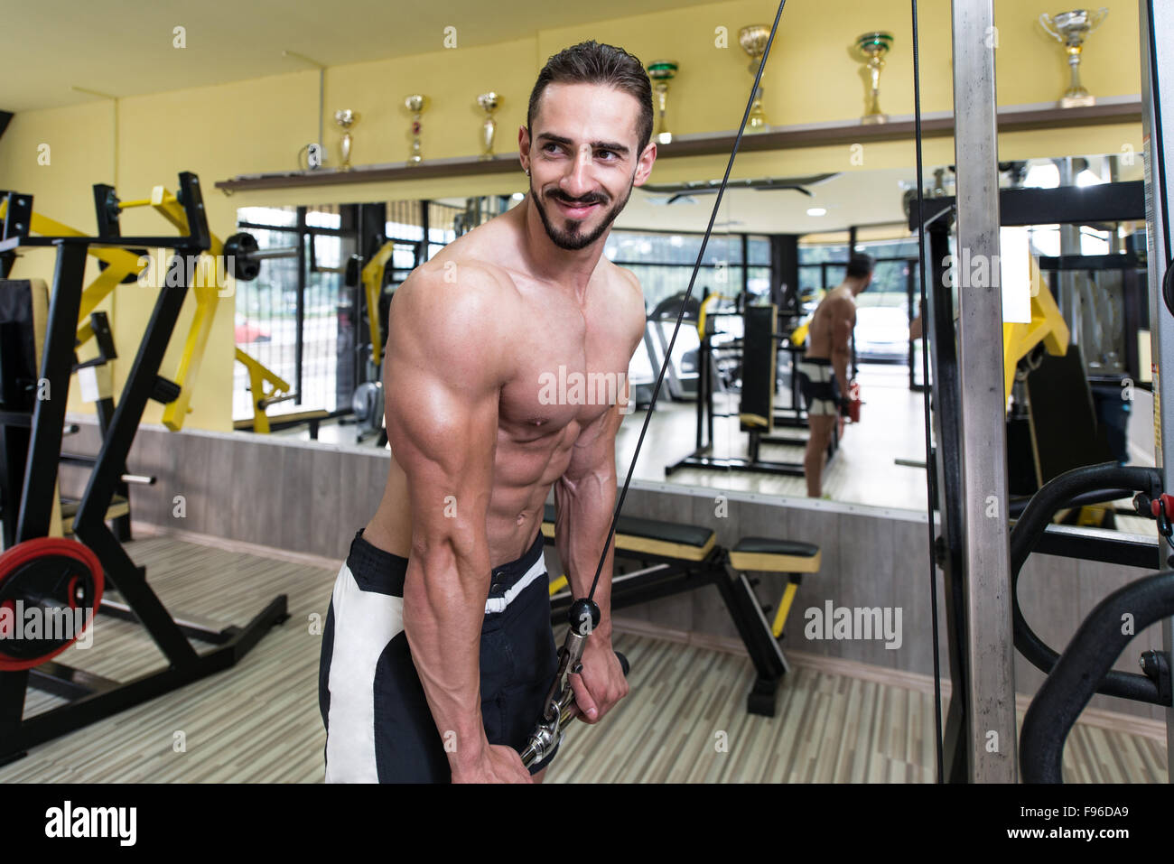 Young Bodybuilder Exercise Triceps In The Gym - He Is Performing Two ...