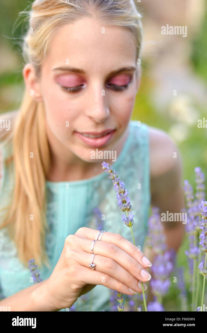 beautiful romantic girl smelling flower lavender Stock Photo - Alamy