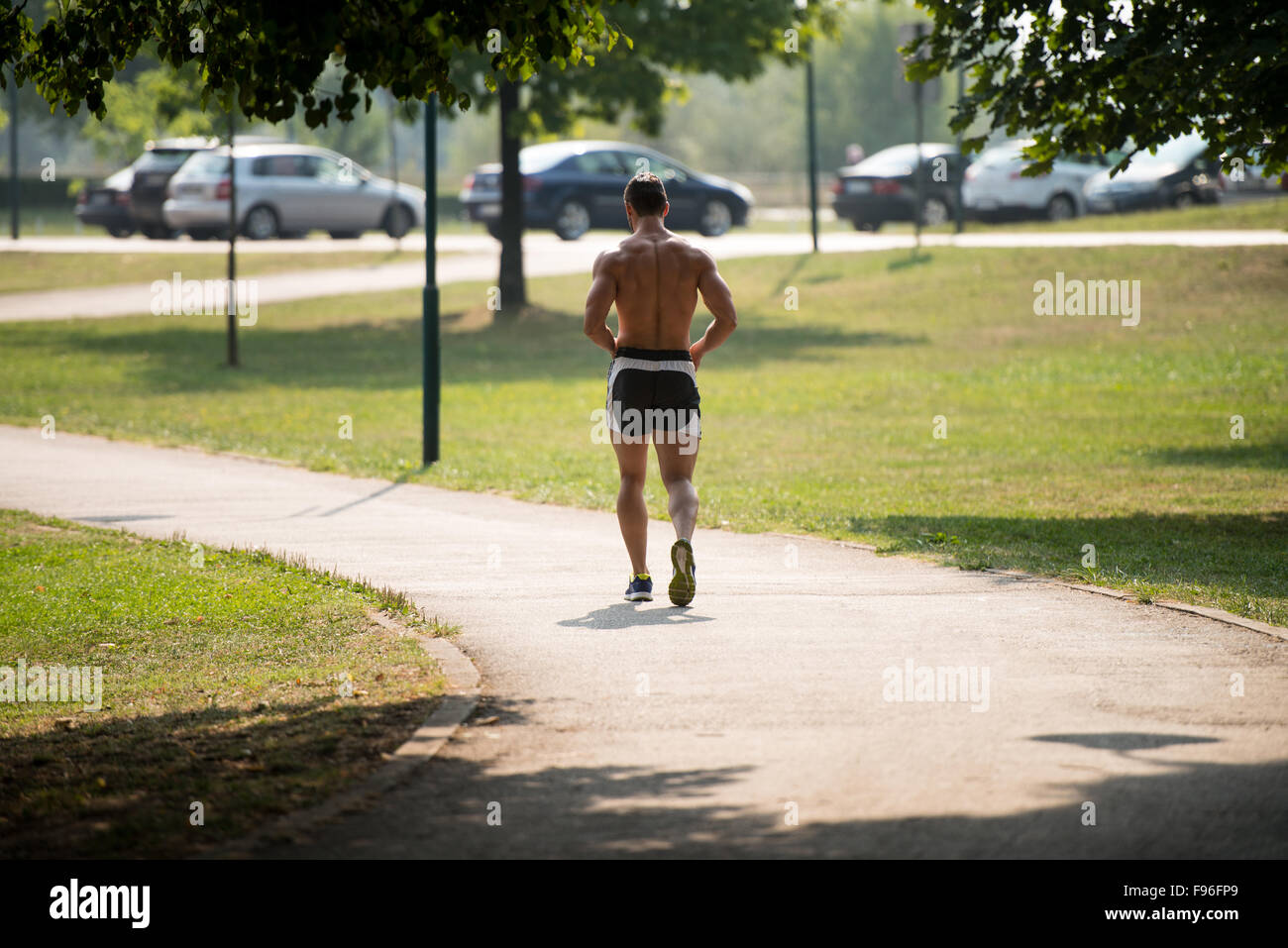 Young Bodybuilder Running In Park Area - Training And Exercising For ...