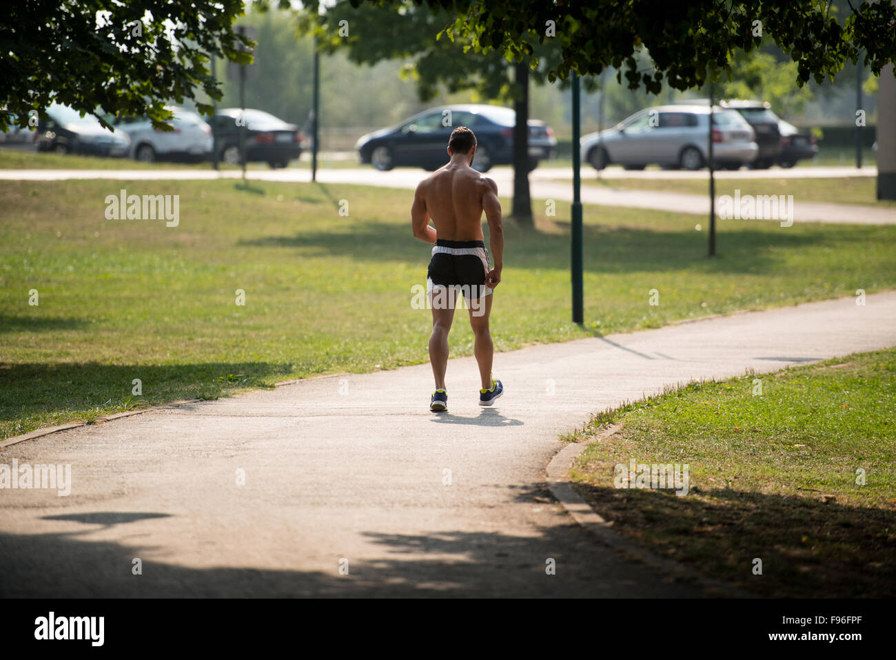Young Bodybuilder Running In Park Area - Training And Exercising For ...