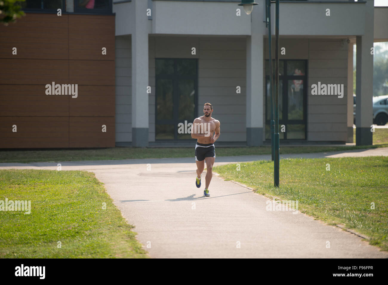 Young Bodybuilder Running In Park Area - Training And Exercising For ...