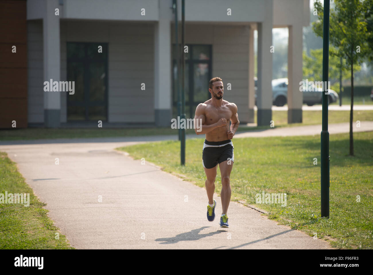 Young Bodybuilder Running In Park Area - Training And Exercising For ...