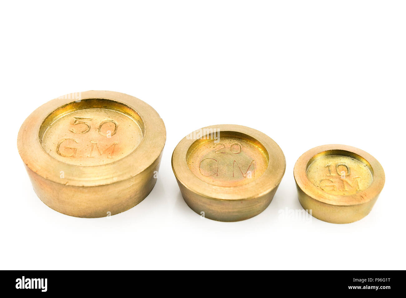 Brass weights of different size isolated on white Stock Photo - Alamy