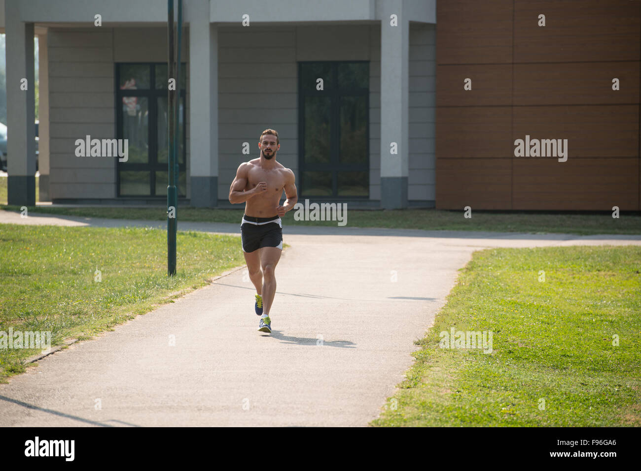 Young Bodybuilder Running In Park Area - Training And Exercising For ...
