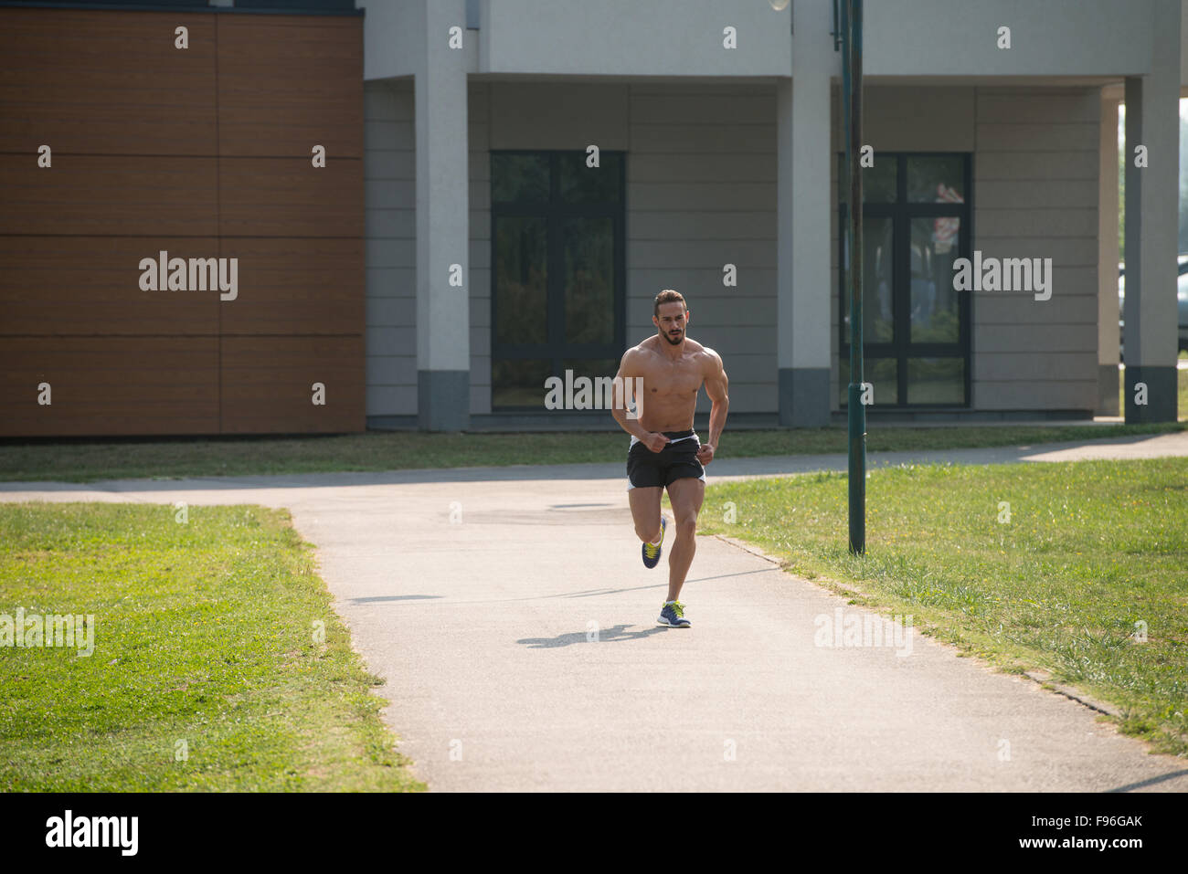Young Bodybuilder Running In Park Area - Training And Exercising For ...