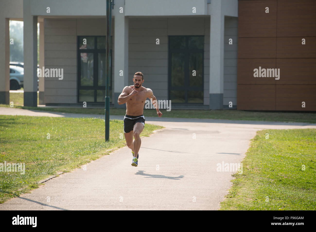 Young Bodybuilder Running In Park Area - Training And Exercising For ...