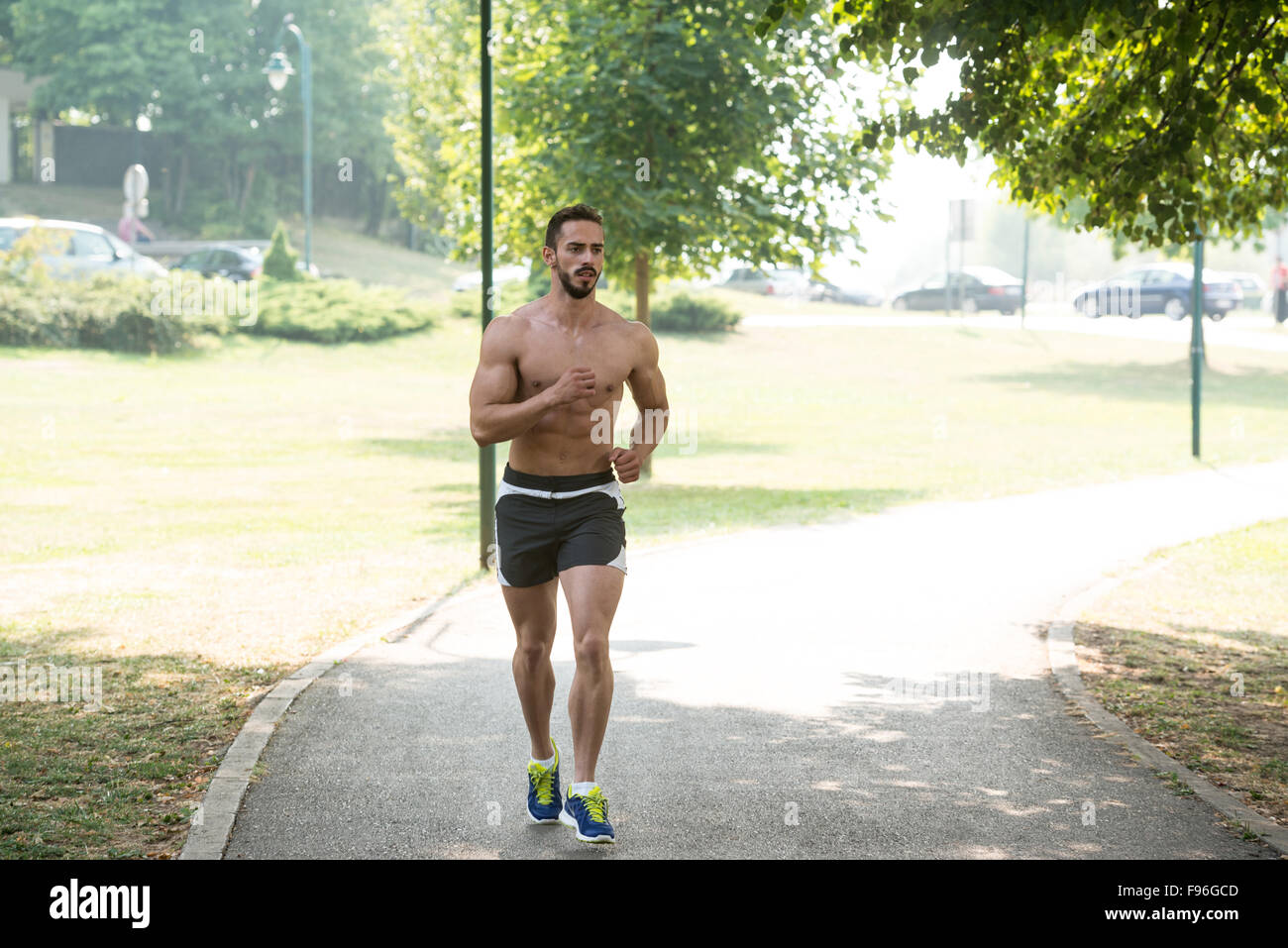 Young Bodybuilder Running In Park Area - Training And Exercising For ...