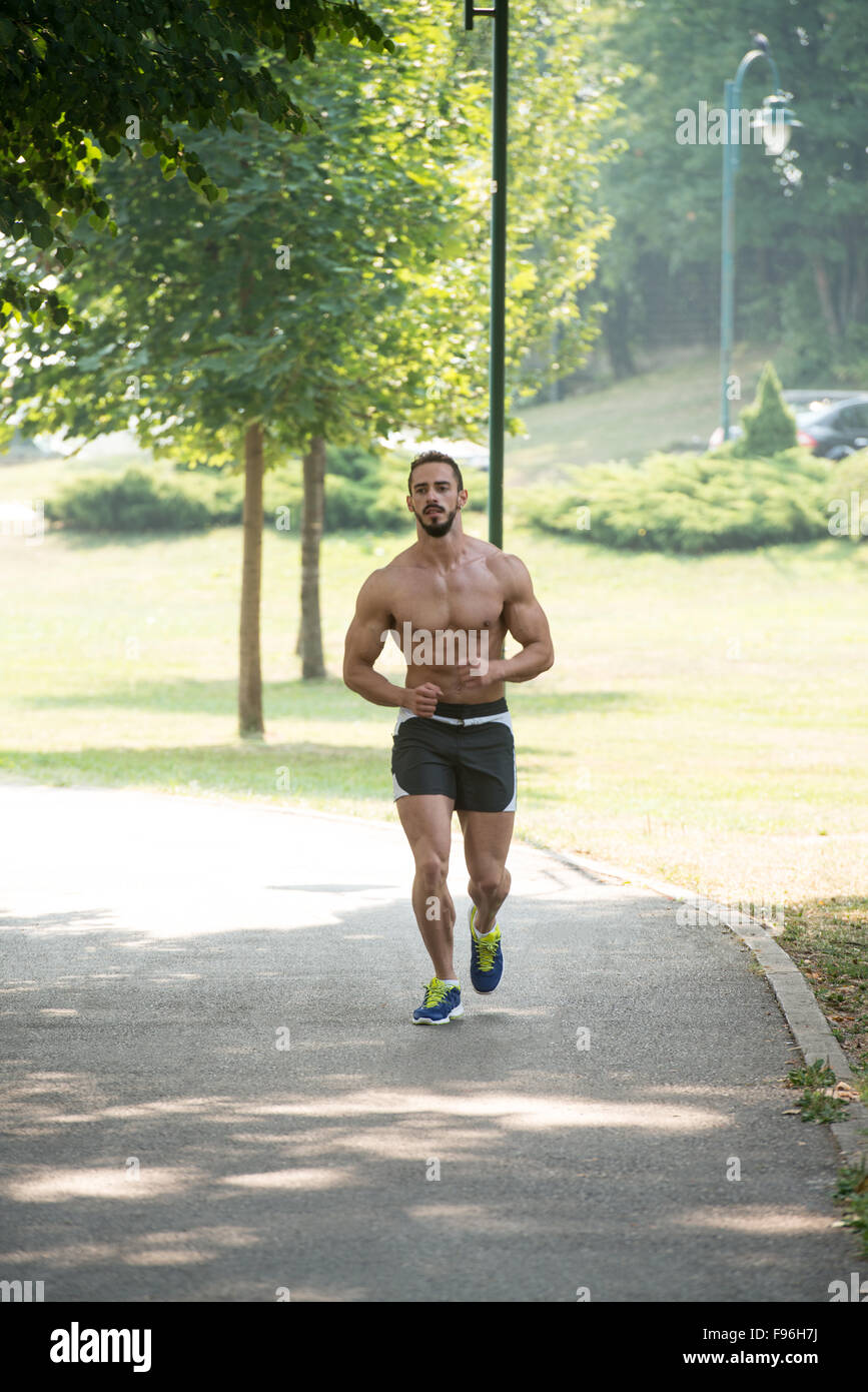 Young Bodybuilder Running In Park Area - Training And Exercising For ...