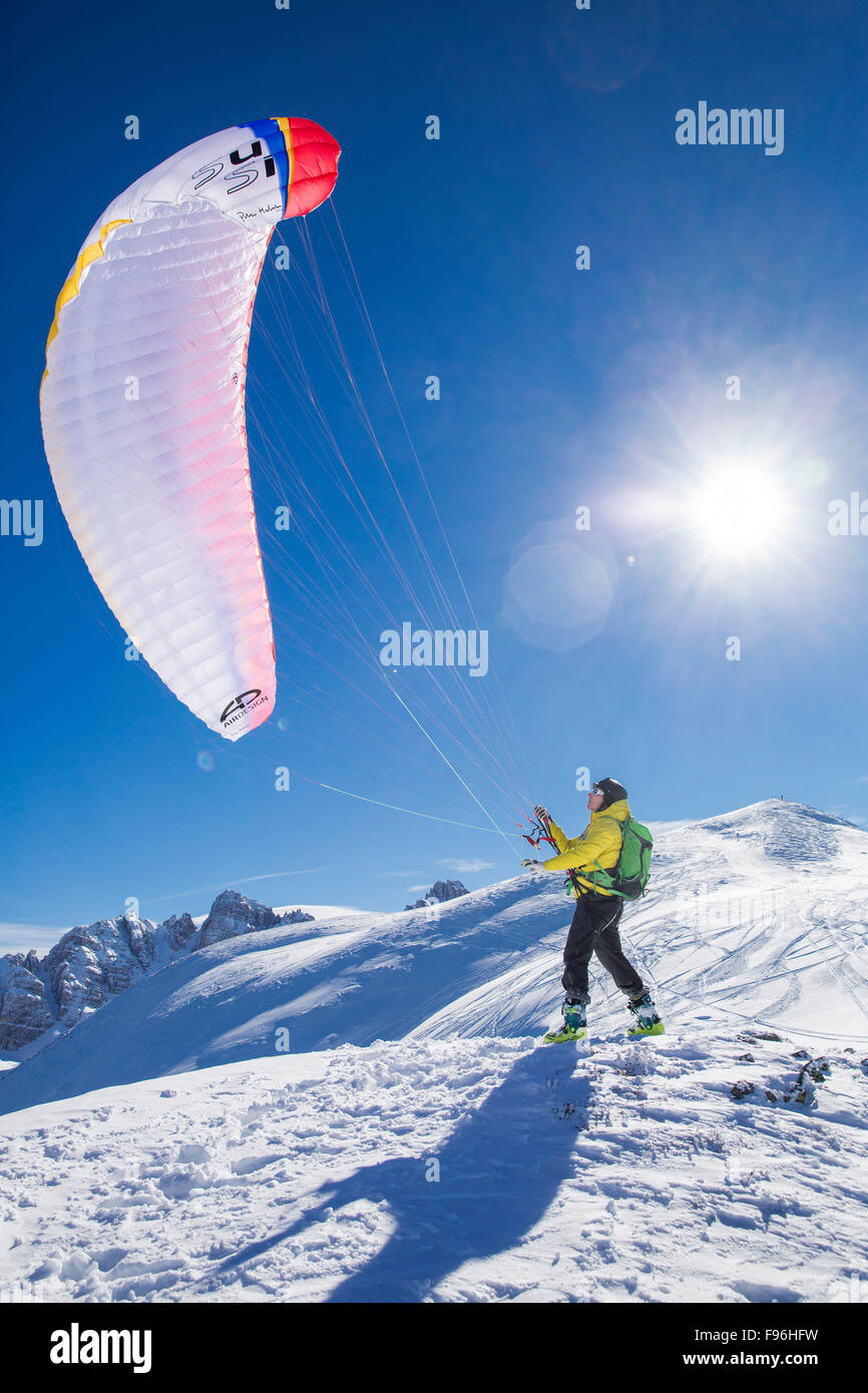 Paraglider, man preparing glider for takeoff, Axamer Lizum, Innsbruck ...
