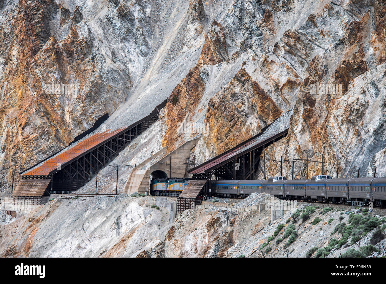 Passenger train about to go through a tunnel in the Thompson River ...