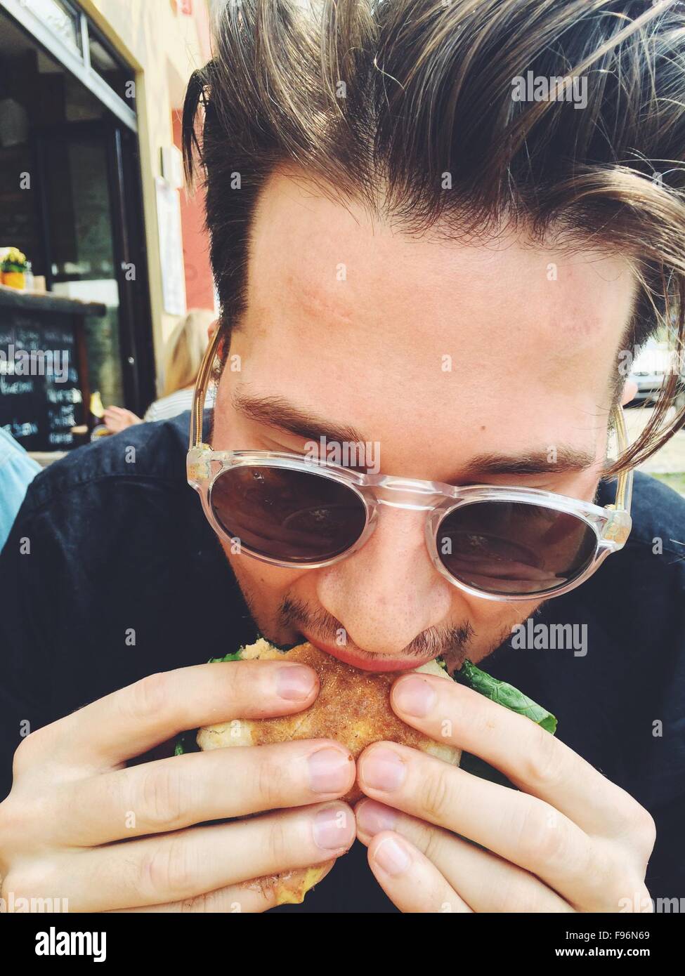Close-Up Of A Young Man Eating Sandwich Stock Photo - Alamy