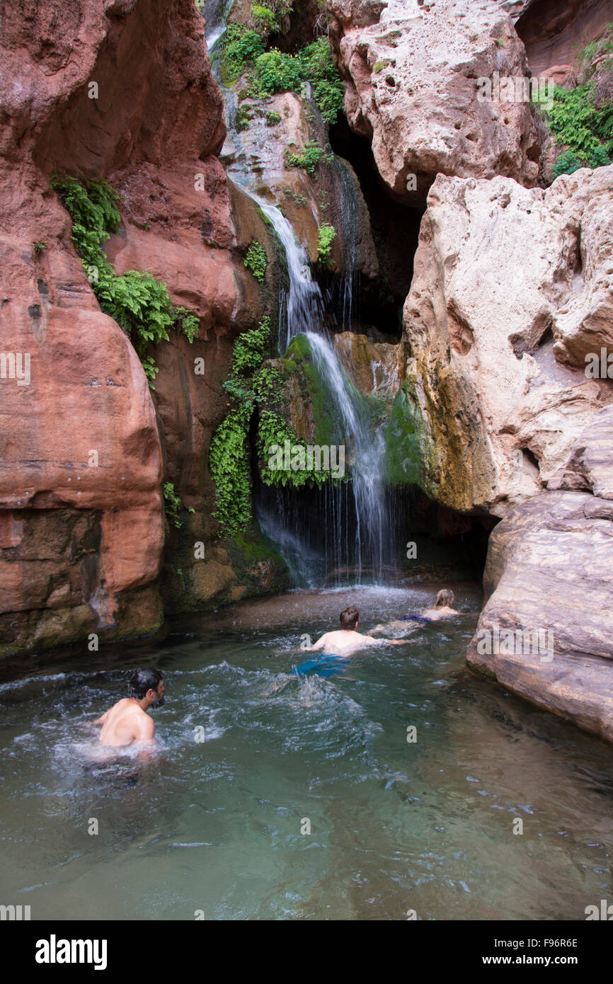 Visitors swim in the spring fed waterfall pool adjacent the Colorado ...