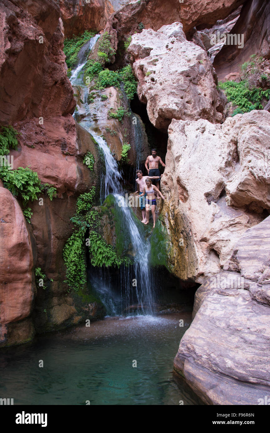 Visitors swim in the spring fed waterfall pool adjacent the Colorado ...