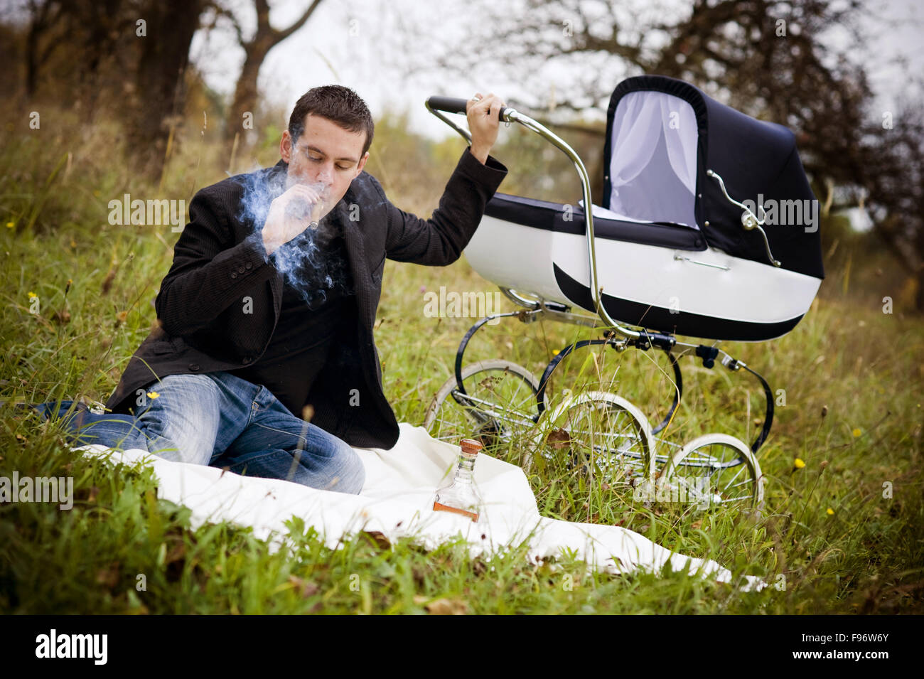 Happy father with baby in vintage pram relaxing together golden and ...