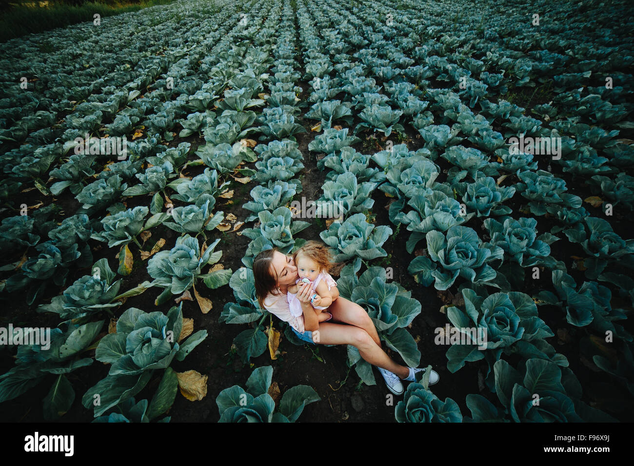 Mother and daughter on the field with cabbage Stock Photo - Alamy