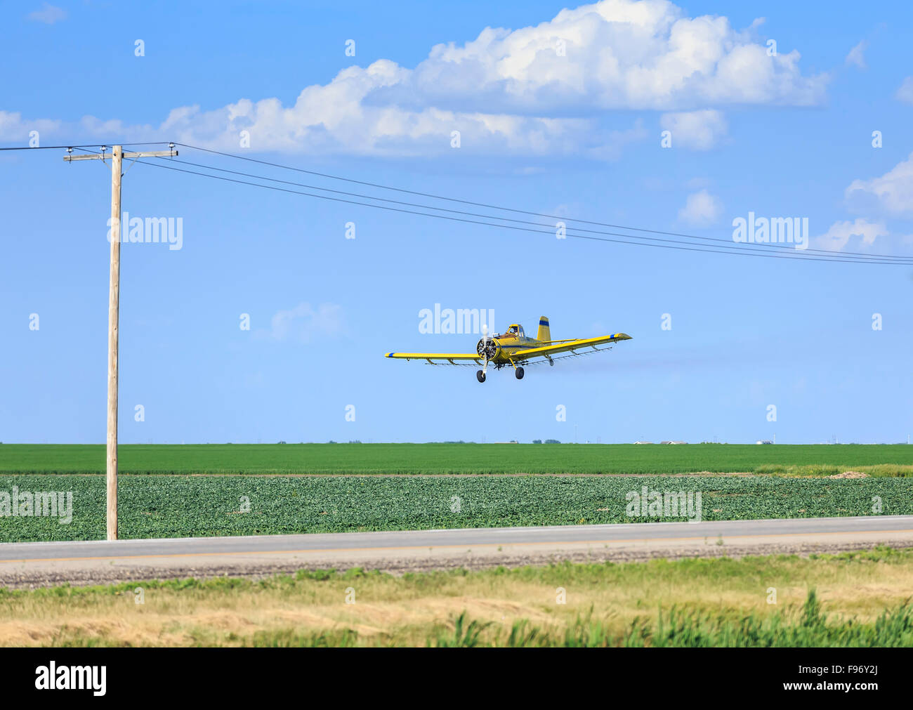 Crop duster airplane spraying field near power lines, Saskatchewan ...