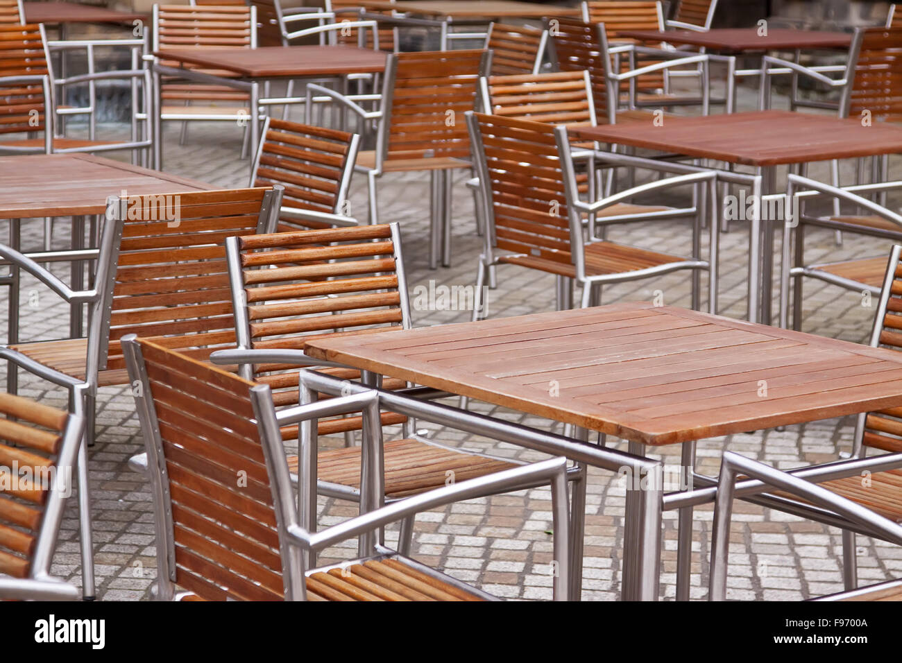 Street cafe with simple tables and chair Stock Photo - Alamy