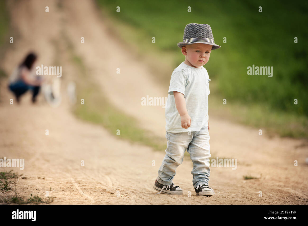 Little boy walking on the footpath in field Stock Photo - Alamy