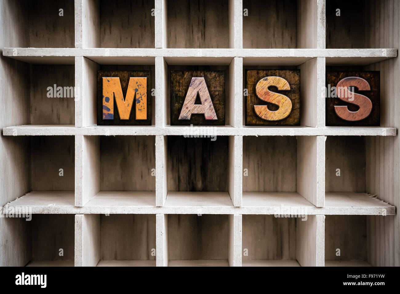The word "MASS" written in vintage ink stained wooden letterpress type ...