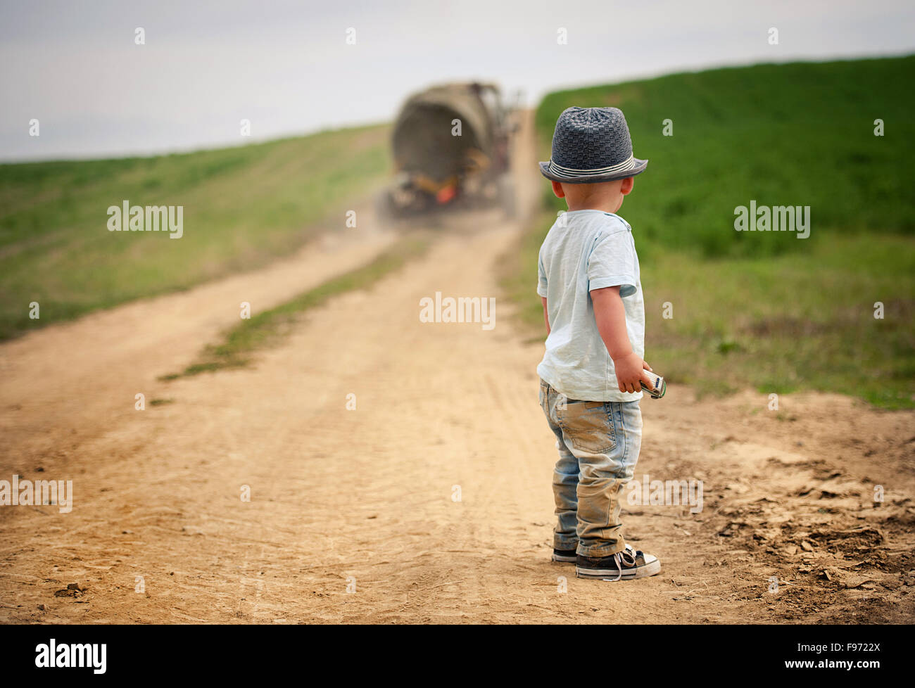 Little boy walking on the footpath in field Stock Photo - Alamy