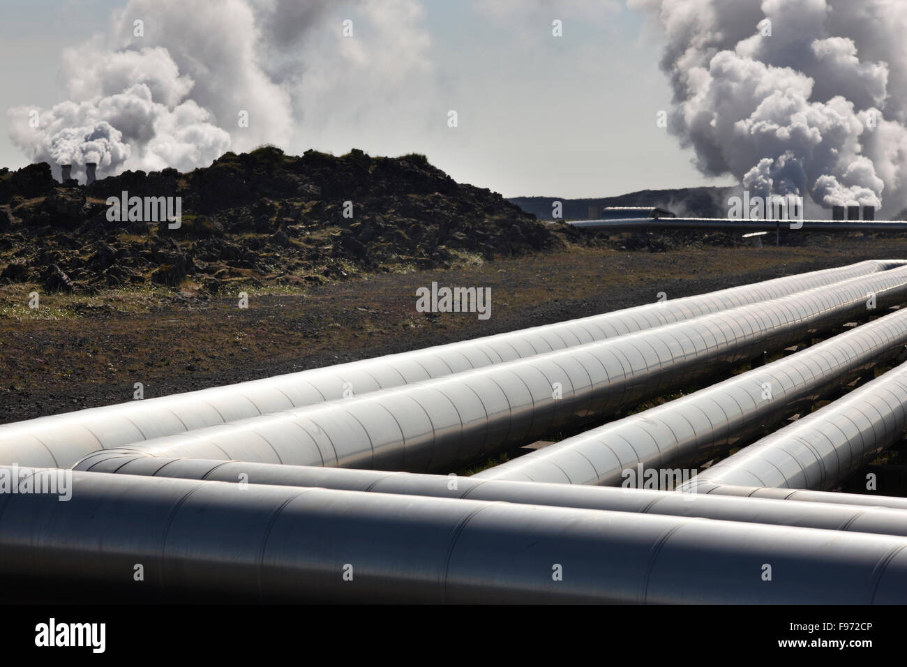 Geothermal pipes and power station on volcanic rocks landscape in ...