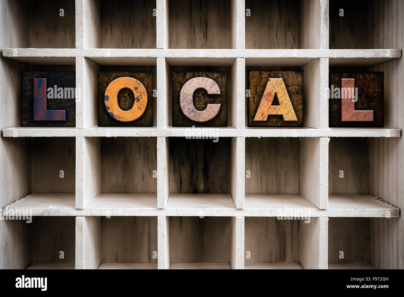 The word "LOCAL" written in vintage ink stained wooden letterpress type ...