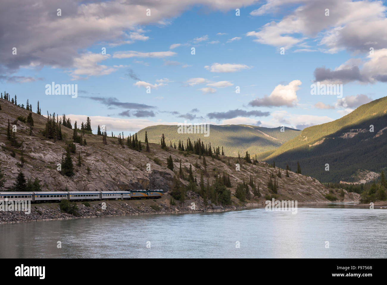 Passenger train along the Athabasca River in, Alberta, Canada Stock ...