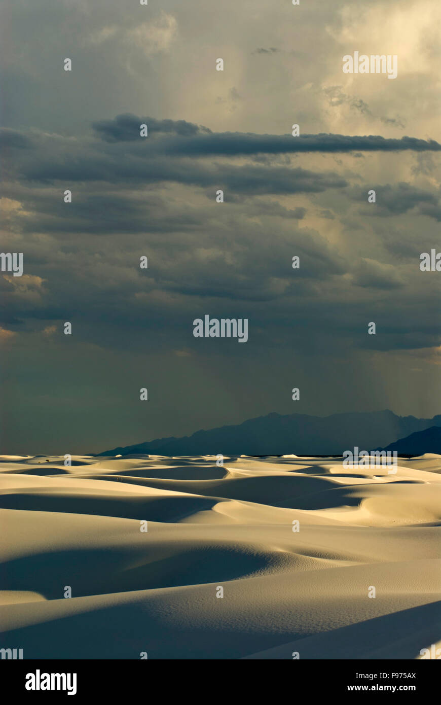 Summer rain storm in background of gypsum sand dunes and surrounding ...