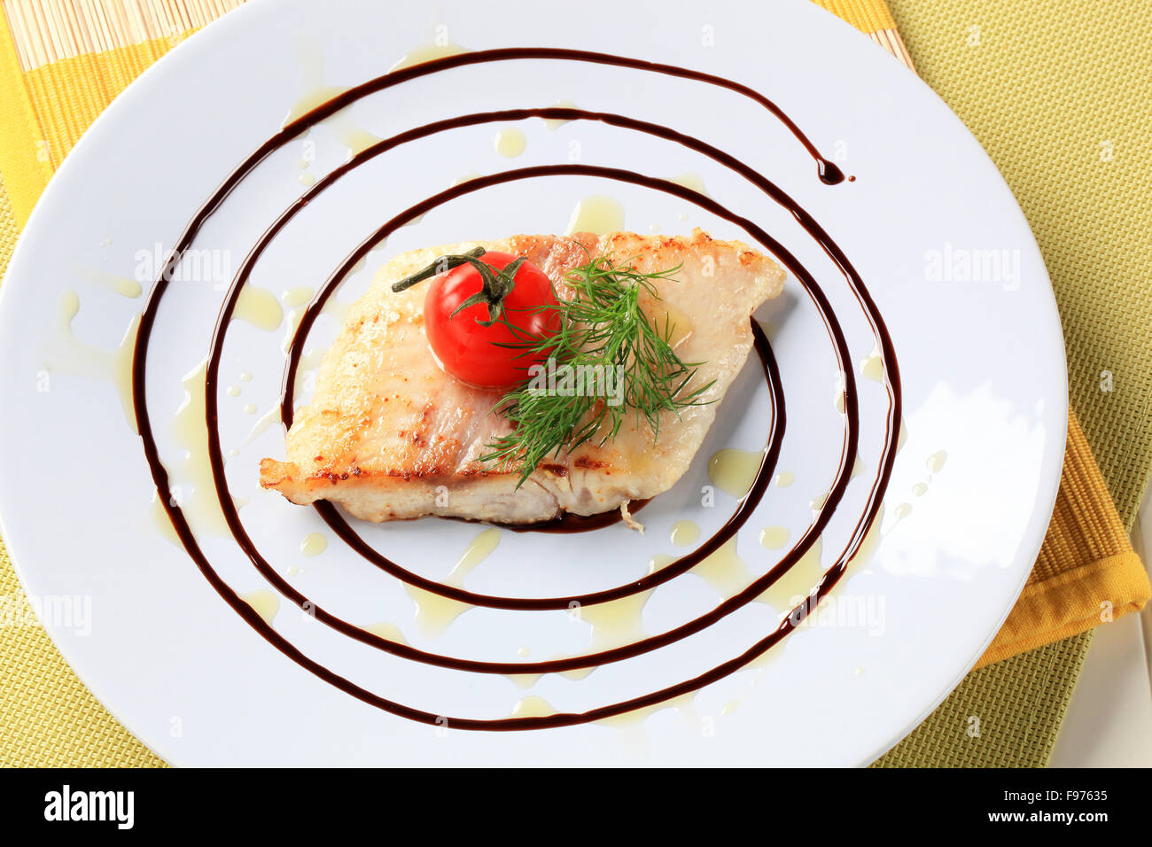 Fish fillet garnished with balsamic vinegar Stock Photo - Alamy