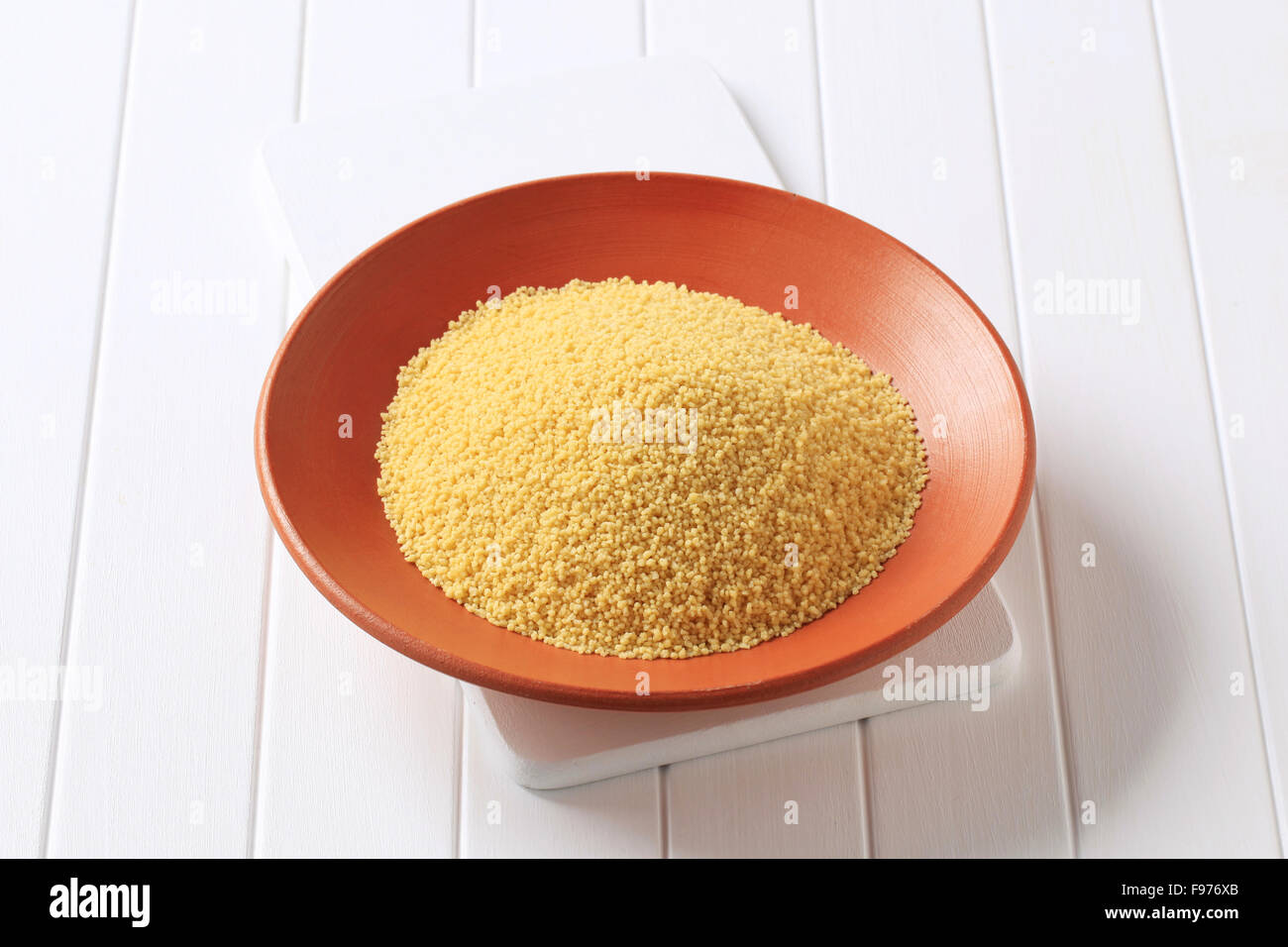 Dried couscous in a terracotta bowl Stock Photo - Alamy