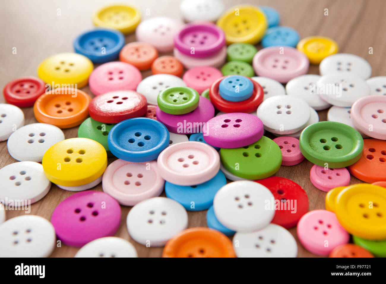 many different colorful buttons to sew as a background Stock Photo - Alamy